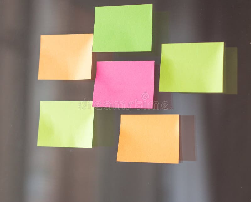 Close-up of Sticky Multicolored Notes on a Glass Wall in the Office ...
