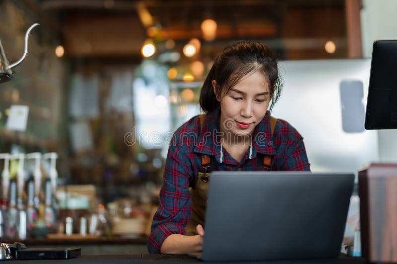 Close-up Store Owner Smiling Face when Typing on Laptop Computer ...