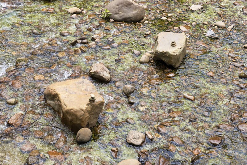 Close Up of a Stream Bed with Small Stacked Rocks on Boulders Stock ...