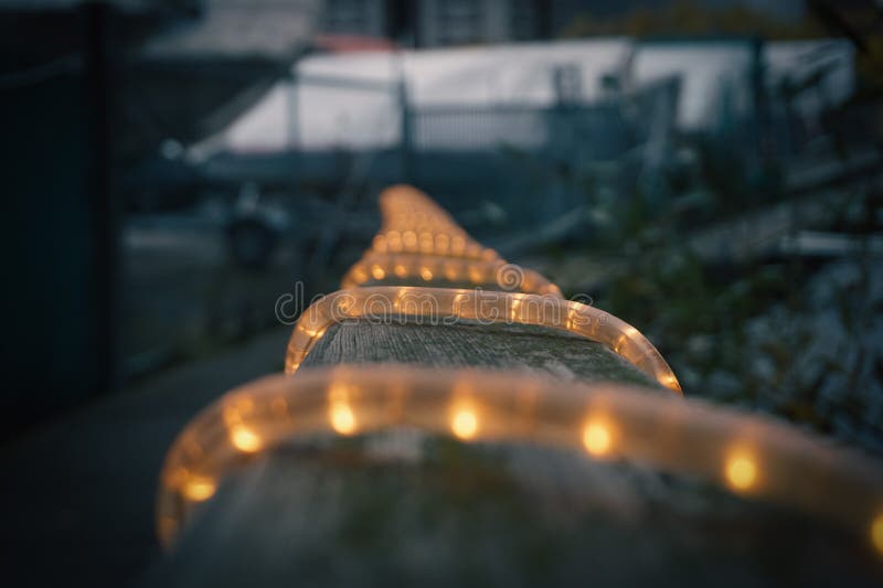 Close-up of a String of Lights Wrapped Around the Fence Stock Photo ...
