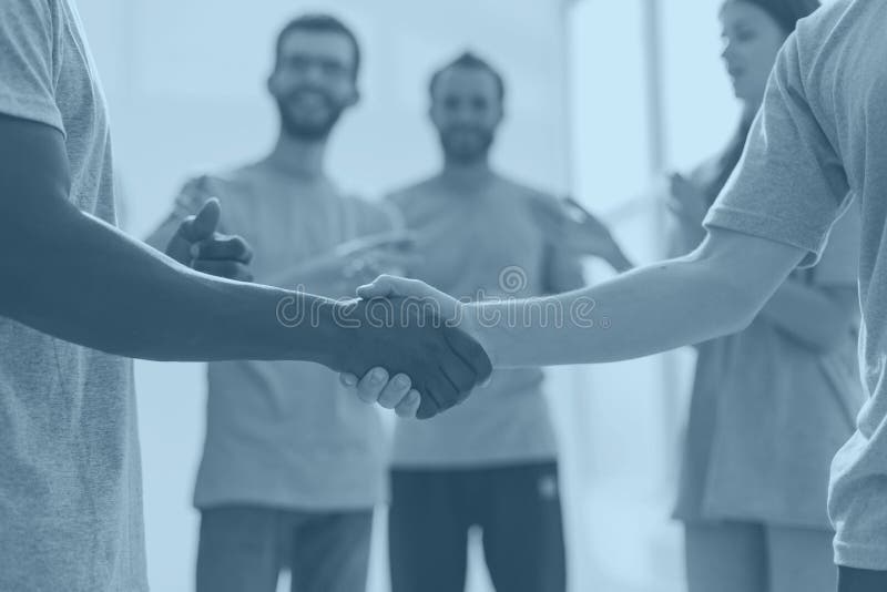 Close Up. Strong Handshake of Two Students of Different Nationalities ...