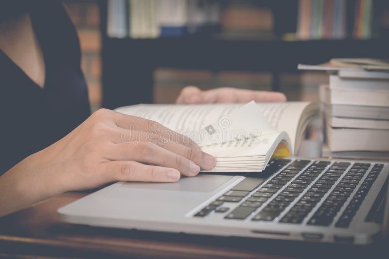 Close Up of Student Hand Reading a Book at Library Vintage Tone. Stock ...