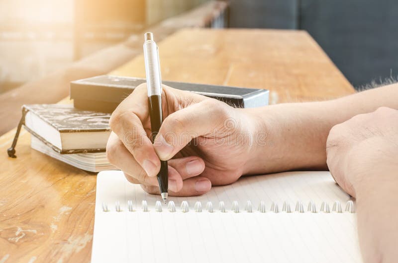 Close Up of Student Hand Writing on Book with Pen Stock Image - Image ...