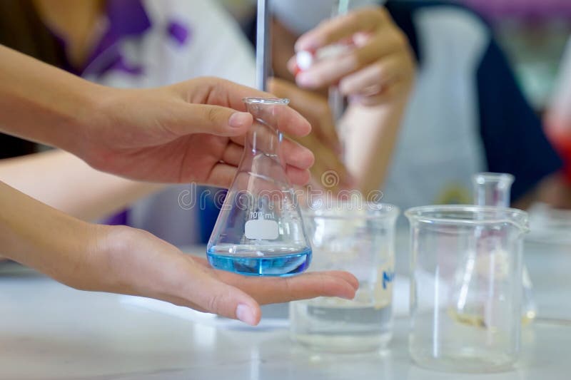 Close-up of a Student Performing an Acid-base Titration Experiment ...