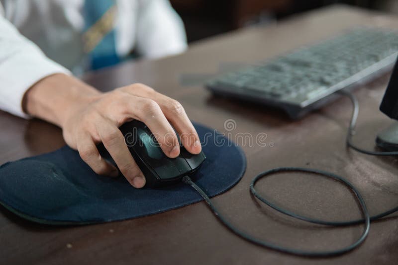 Close Up of Student& X27;s Hand Holding the Mouse Next To the Keyboard ...