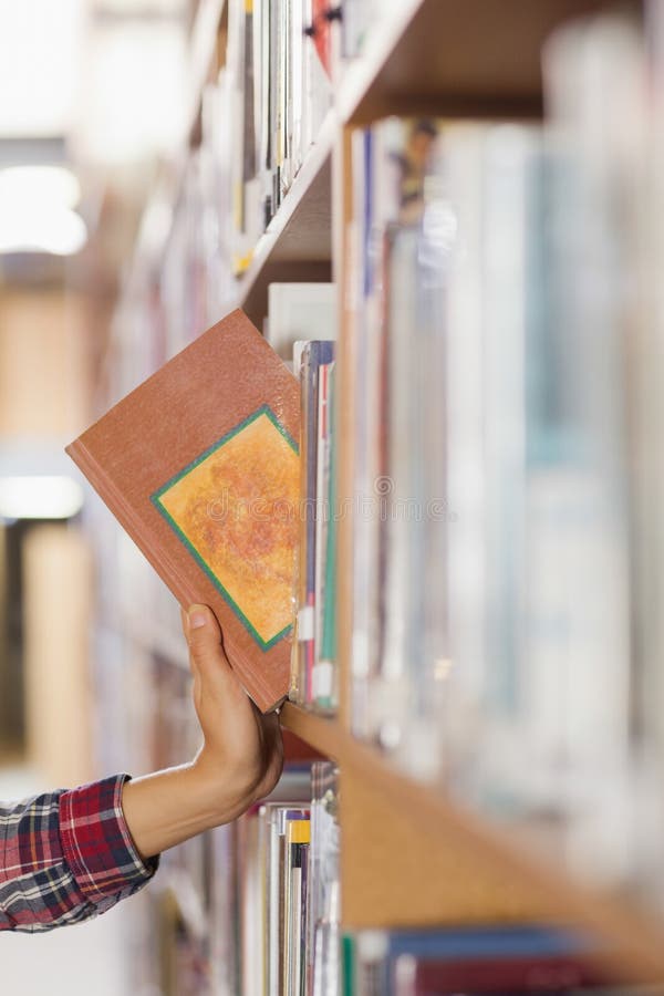 Close Up of Student Taking Book Out of Shelf Stock Image - Image of ...