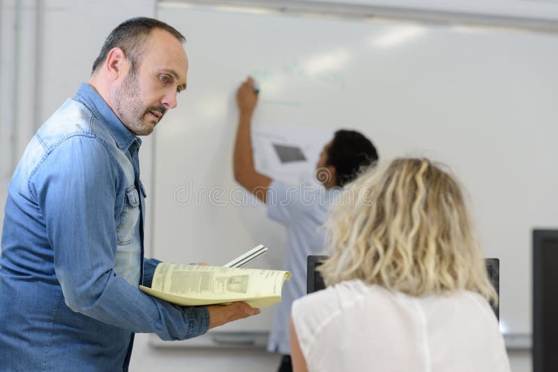 Close Up Student Talking To Teacher Stock Photo - Image of classroom ...