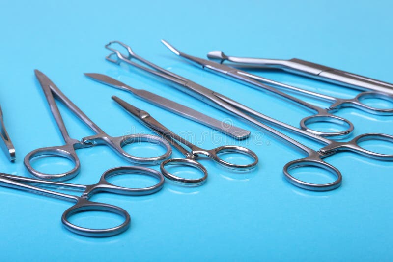 Close Up Surgical Instruments and Tools on Blue Mirror Background ...