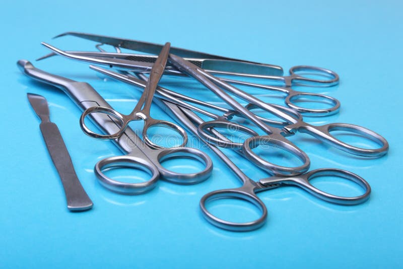 Close Up Surgical Instruments and Tools on Blue Mirror Background ...