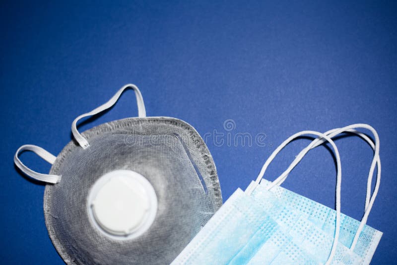 Close-up of Surgical Mask and Flu Protection Mask on Background of ...