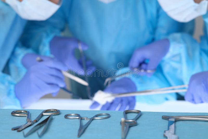 Close Up of Surgical Tools while Group of Surgeons at Work in Operating ...