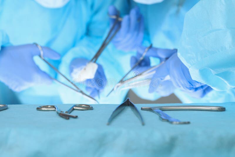 Close Up of Surgical Tools while Group of Surgeons at Work in Operating ...