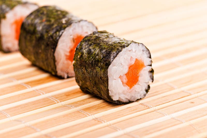 Close-up of Sushi in Row on Bamboo Mat Stock Image - Image of healthy ...