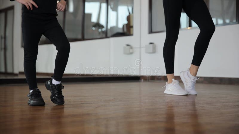 Close-up of the Synchronized Movements of the Legs of a Trainer and a ...