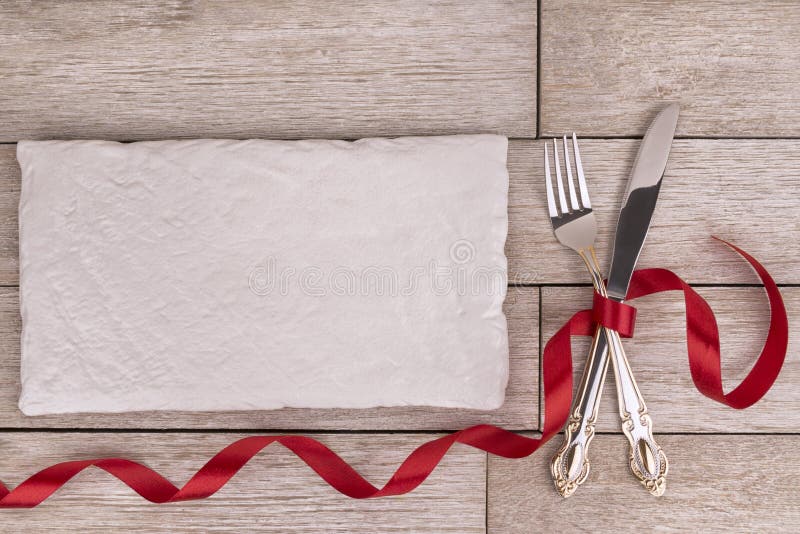Close Up on Table Settings with a Decorative Red Bow on Silverware ...