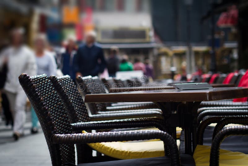 Close Up of Tables of Restaurant with People Walking by in the B Stock ...