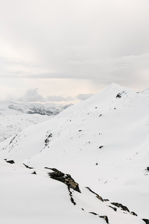 Close-up of a Tall Mountain with a Sharp Peak Covered with Snow, with ...