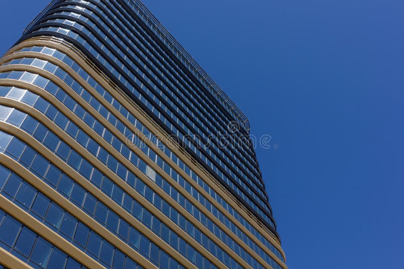 A Close-up of a Tall Skyscraper Corner Against the Sky. Glass ...