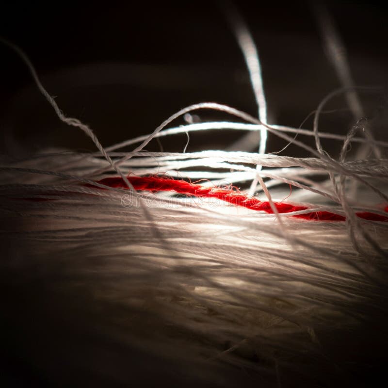 Close-up of Tangled White Threads with a Single Prominent Red Thread ...