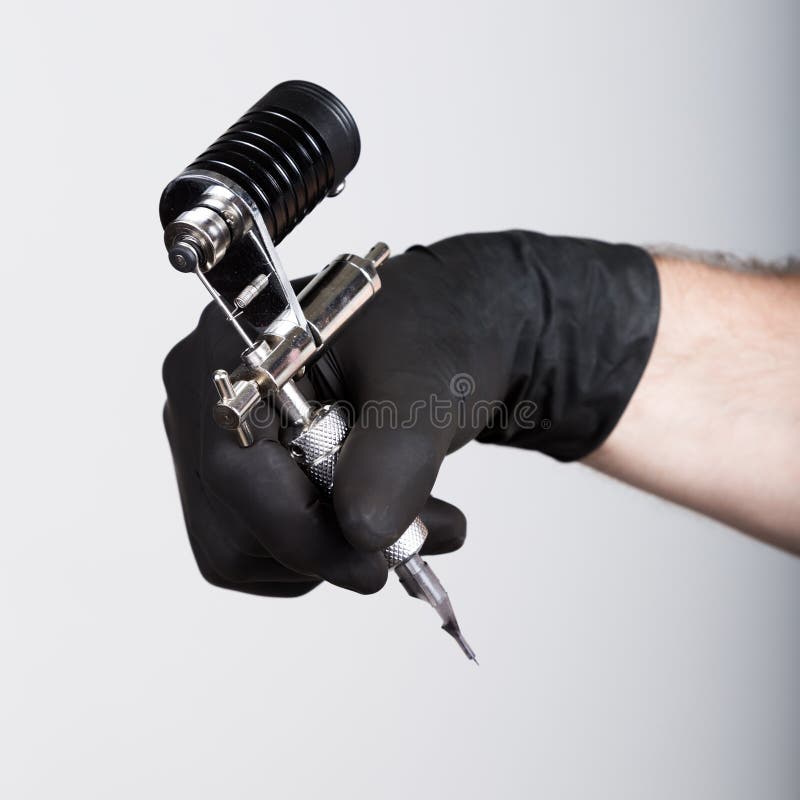 Close-up of Tattooist Hands in Black Gloves with Tattoo Machine Stock ...