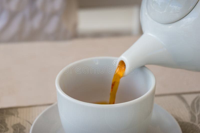 Close Up of Tea Pouring in a White Tea Cup Stock Photo - Image of ...