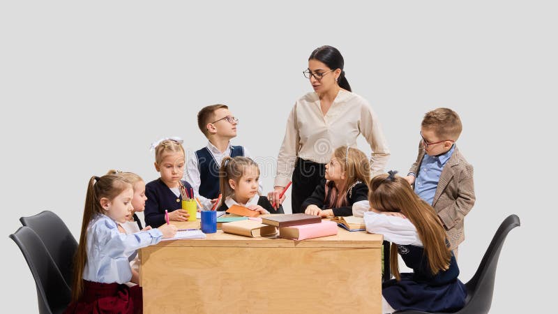 Close-up of Teacher Explaining with Red Pencil while Students Sit ...