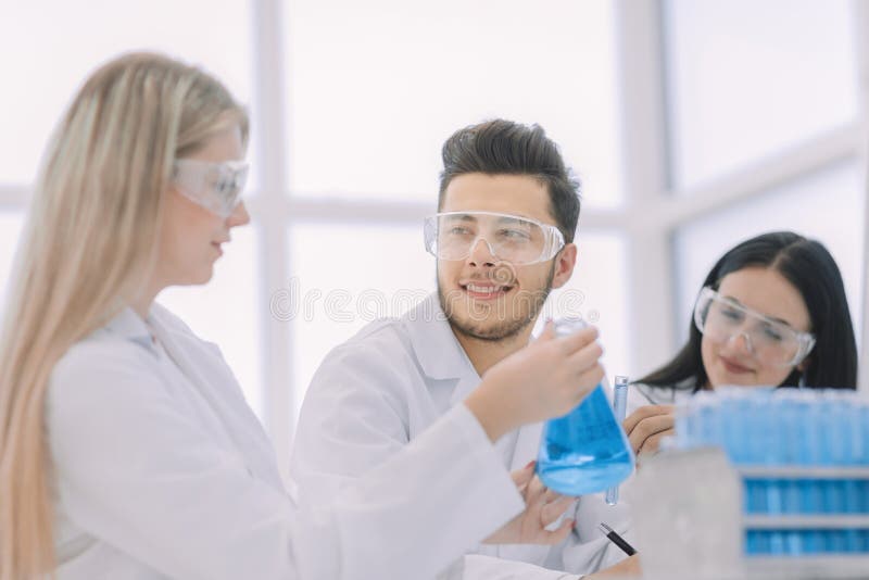 Close Up.a Team of Scientists Sitting at the Laboratory Table Stock ... Close Up.a Team of Scientists Sitting at the Laboratory Table Stock ...