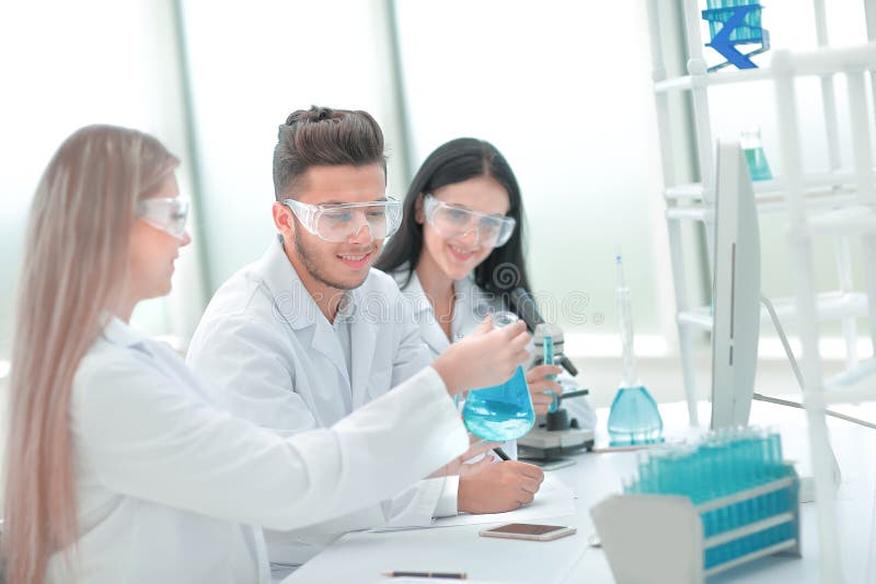 Close Up.a Team of Scientists Sitting at the Laboratory Table Stock ...