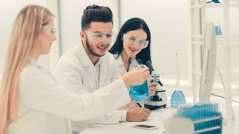 Close Up.a Team of Scientists Sitting at the Laboratory Table Stock ...