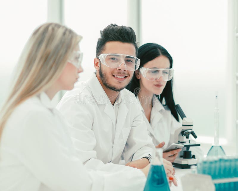Close Up.a Team of Scientists Use a Computer To Check the Data Stock ... Close Up.a Team of Scientists Use a Computer To Check the Data Stock ...