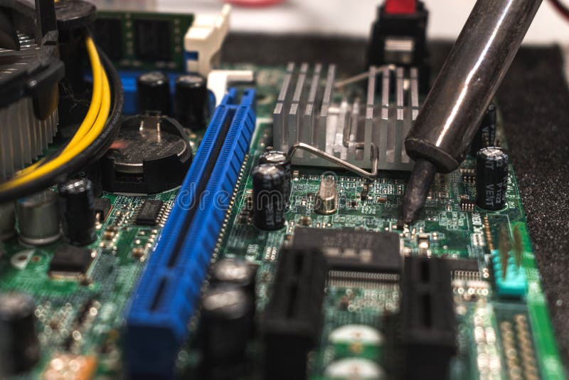Close Up of a it Technician Soldering a Part of a Computer Motherboard ...