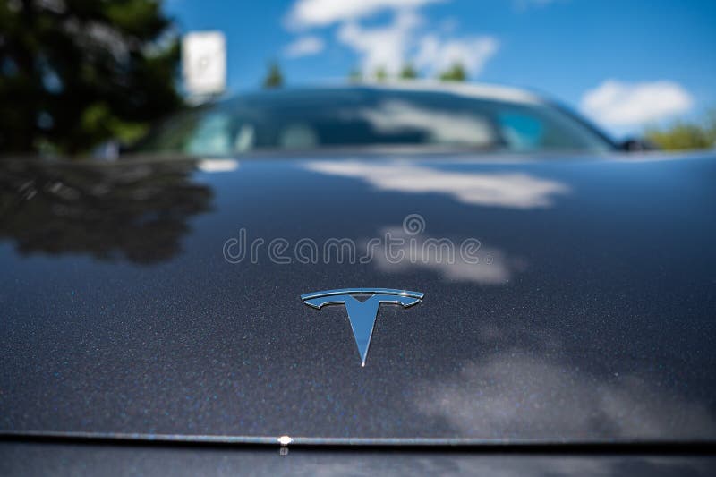 Close-up of a Tesla Icon on the Hood of a Black Car. Editorial Photo ...
