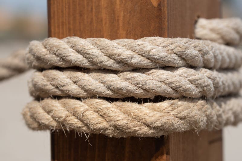 Close-up and Texture of a Twisted Hemp Rope Wrapped Around a Wooden ...