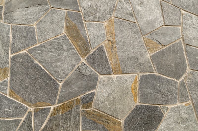 A Close-up of a Textured Stone Wall with Irregularly Shaped Stones ...