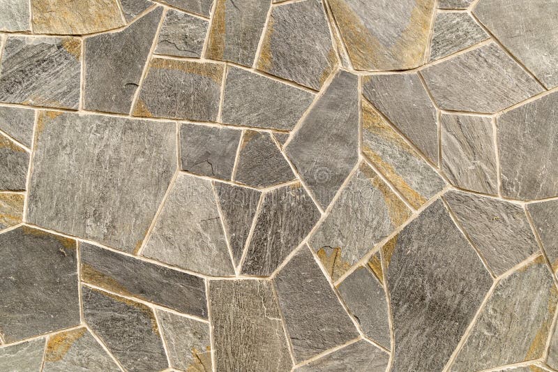 A Close-up of a Textured Stone Wall with Irregularly Shaped Stones ...