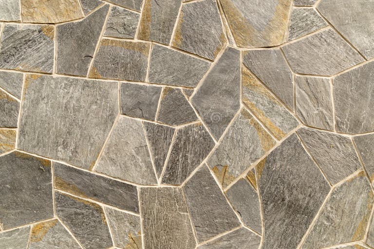 A Close-up of a Textured Stone Wall with Irregularly Shaped Stones ...