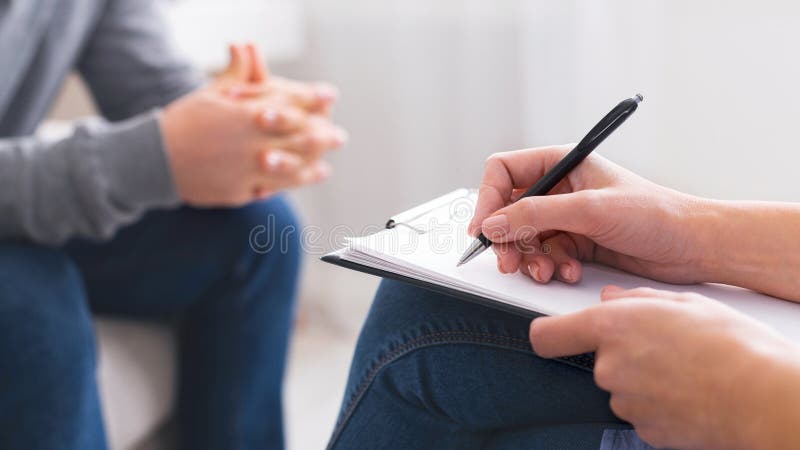 Close-Up of a Therapist Taking Notes during a Counseling Session Stock ...