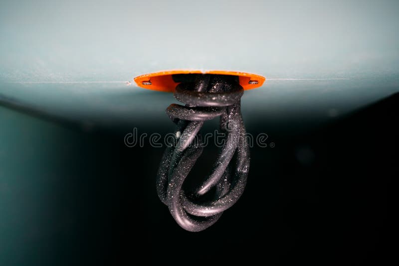 Close-up of a Thick Black Wire Sticking Out of an Orange Round Drywall ...
