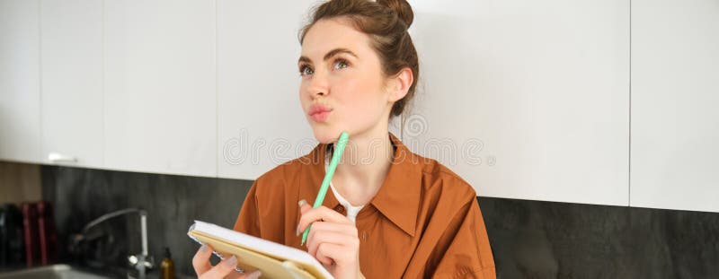 Close Up of Thoughtful Young Woman with Notebook, Looking Up with ...