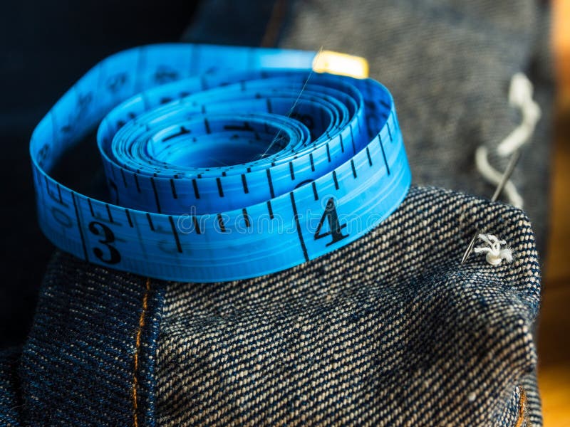 Close-up of a Threaded Needle and Measuring Tape Against a Background ...