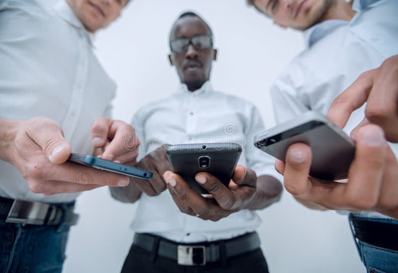 Close Up.three Employees Using Their Smartphones Stock Image - Image of ...