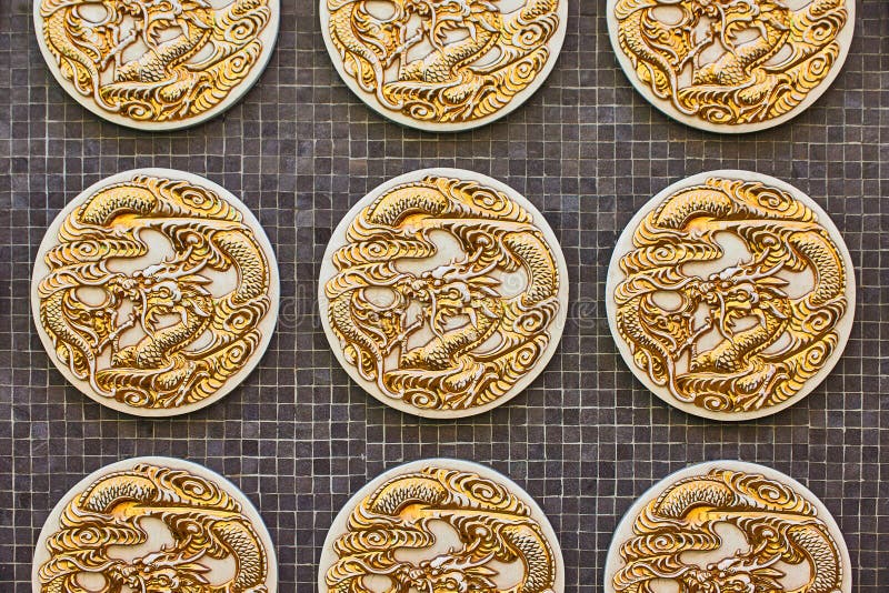 Close Up of Three Golden Dragon Coins on Black Tile Background Stock ...