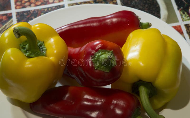 Close-up: Three Red Kapia Peppers and Two Yellow Big Peppers on White ...