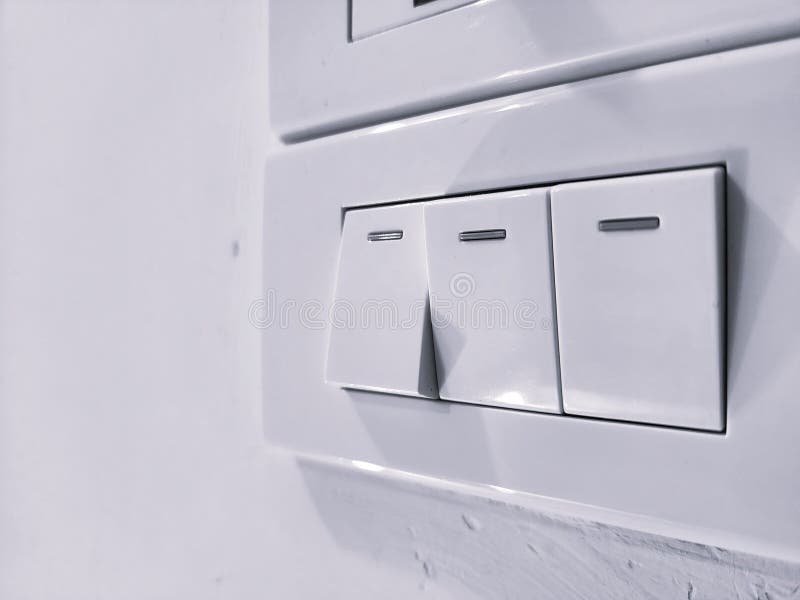 Close-up of Three White Light Switches on a Wall Stock Photo - Image of ...