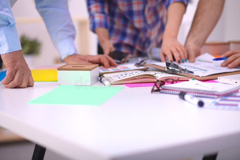 Close-up of Three Young Creative Designers Working on Project Together ...