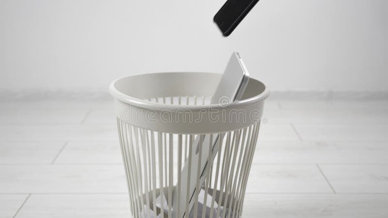 Close-up Throwing Laptop, Headphones, Keyboard To the Trash Bin. the ...