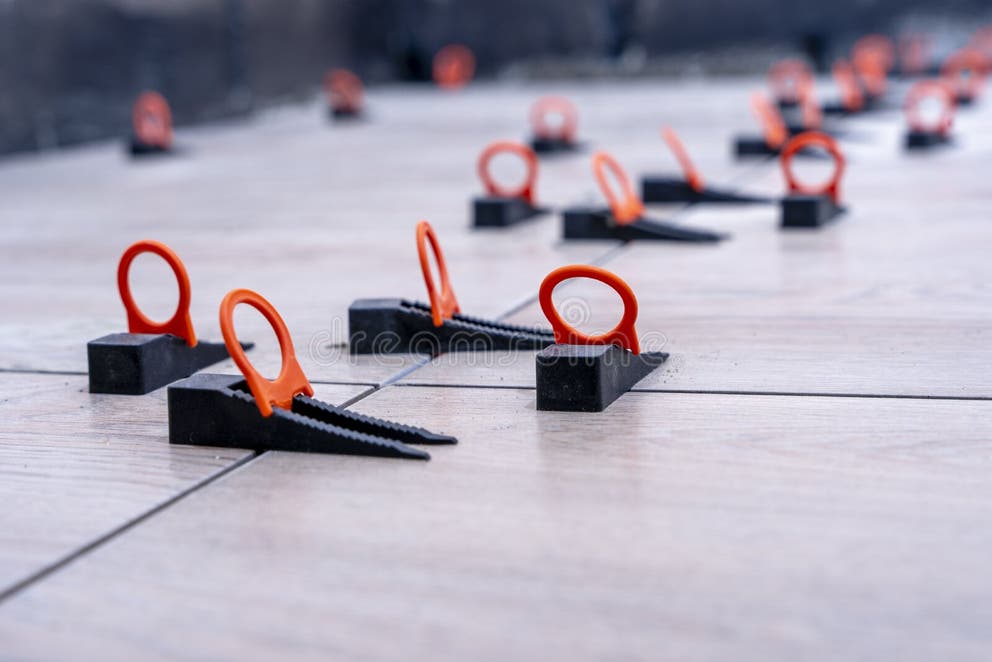 Close-up of the Tile Alignment System Holding Tile in Given Position ...