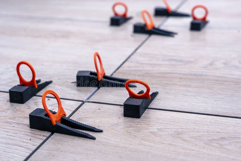 Close-up of the Tile Alignment System Holding Tile in Given Position ...