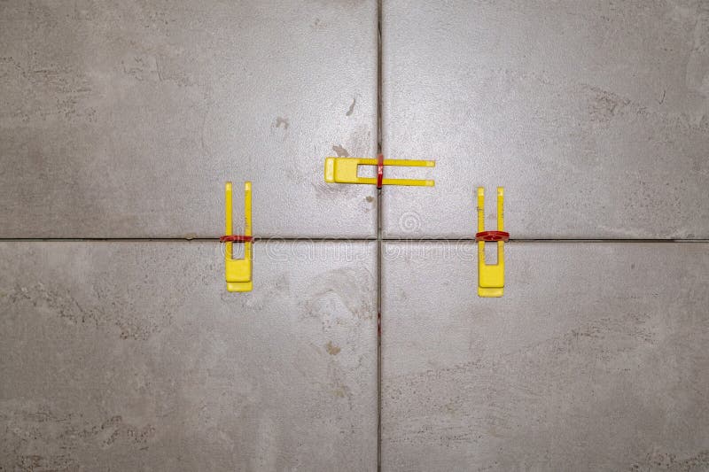 Close-up of Tile Leveling System with Plastic Clips and Wedges in Place ...