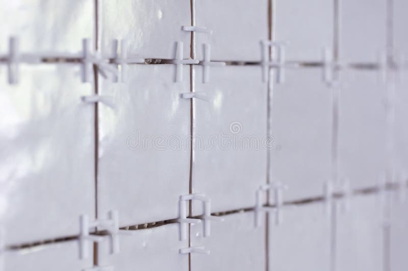 A Close Up of a Tile Wall Under Construction. the Wall is Being Tiled ...